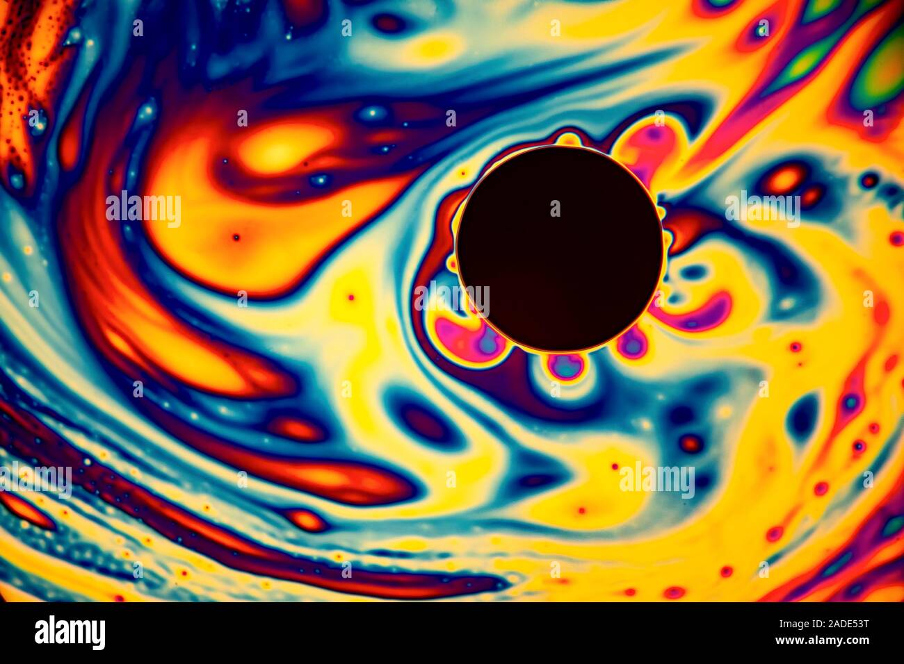 Soap bubble film iridescence. Light micrograph of the surface of a ...