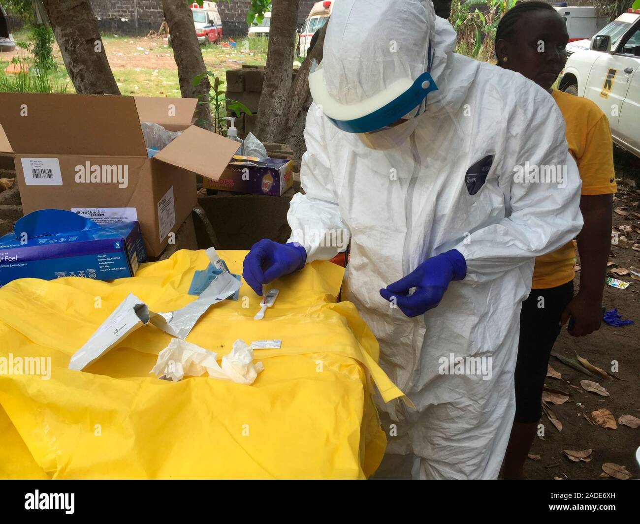 Epidemiologist conducting a diagnostic test for the presence of Ebola ...