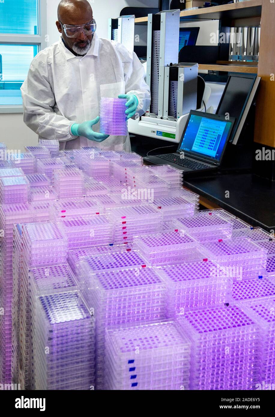 Scientist with serum sample tests in a virology laboratory during ...