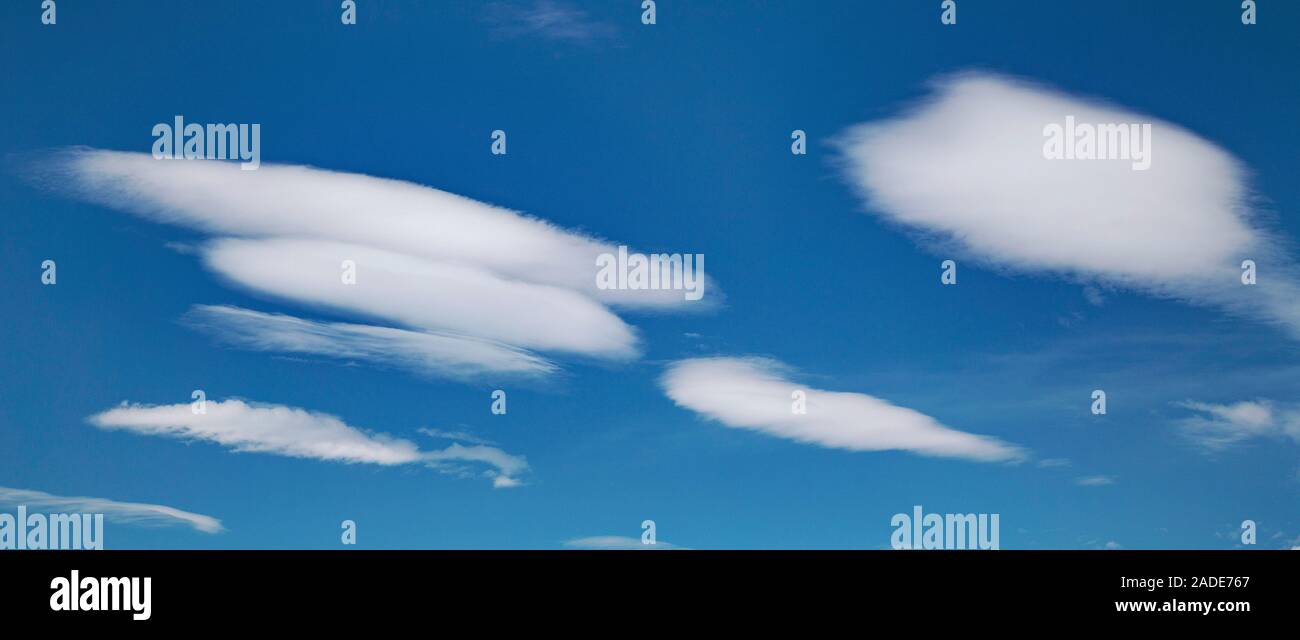 Lenticular clouds (altocumulus lenticularis) in a blue sky. The clouds ...