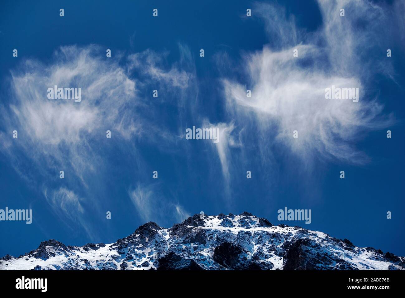 Cirrus spissatus clouds over mountains in spring in New Zealand. Cirrus ...