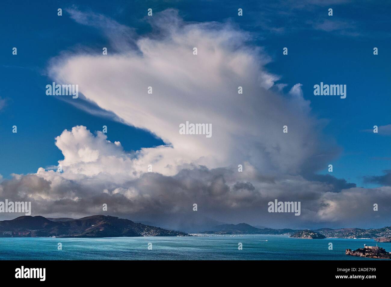 Cumulonimbus cloud, with towering anvil head and rain storm, over San ...