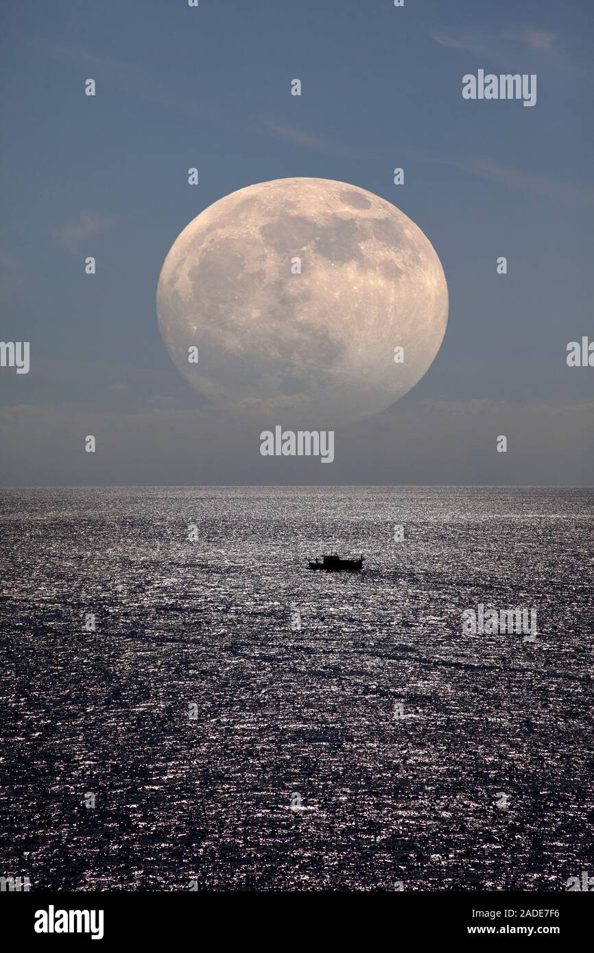 Full Moon rising over the sea Stock Photo - Alamy