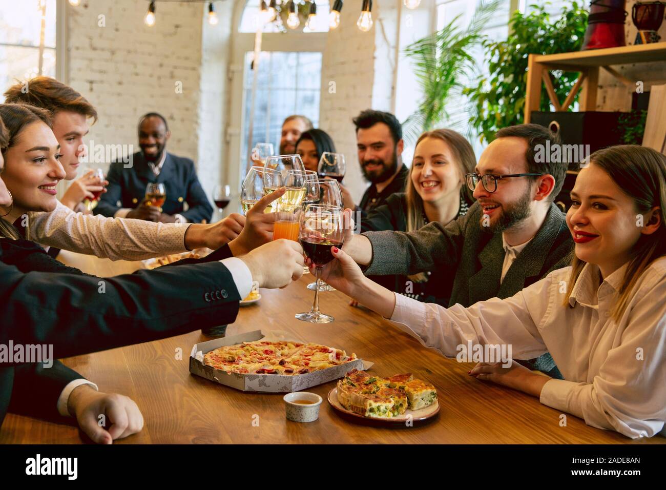 Happy co-workers celebrating while company party and corporate event ...