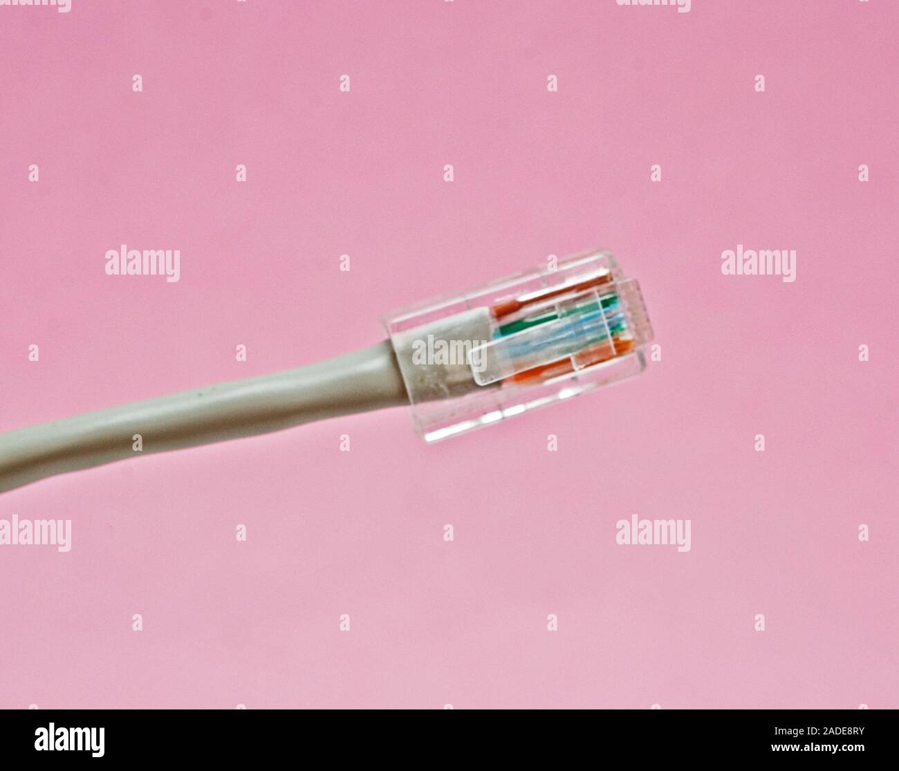 RJ45 (ethernet) plug isolated on pink background Stock Photo - Alamy