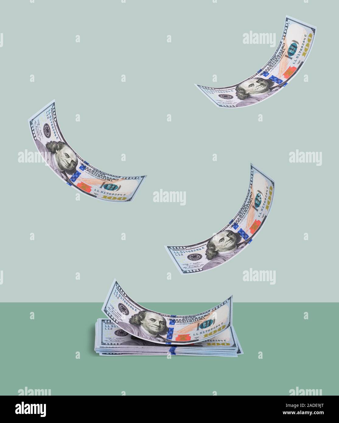 Money falling into an orderly stack Stock Photo - Alamy