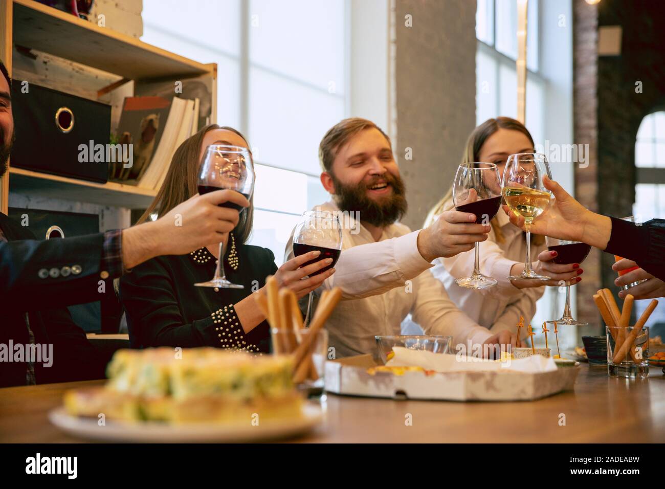 Happy co-workers celebrating while company party and corporate event ...