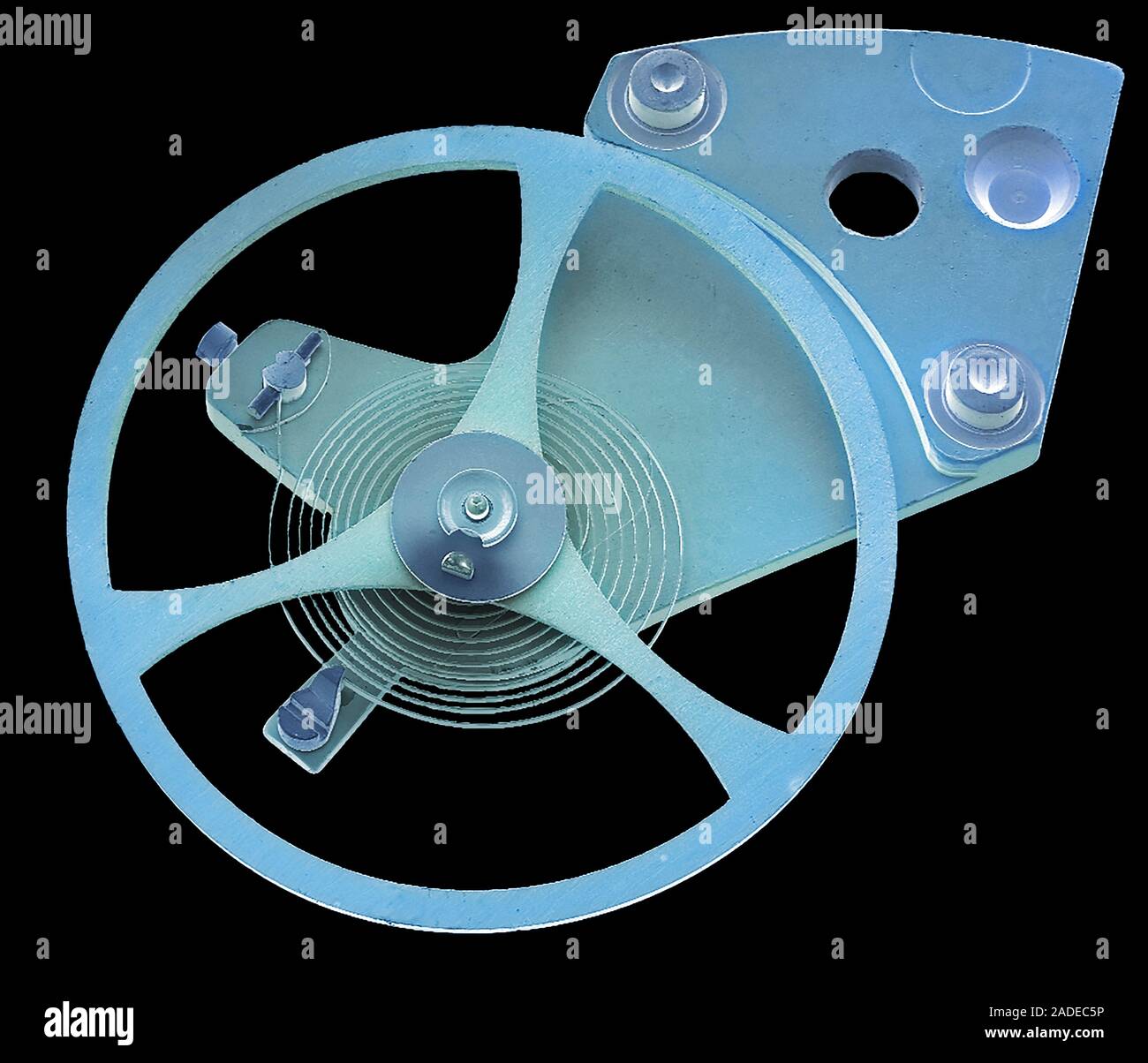 Watch balance wheel. Coloured scanning electron micrograph (SEM). A ...