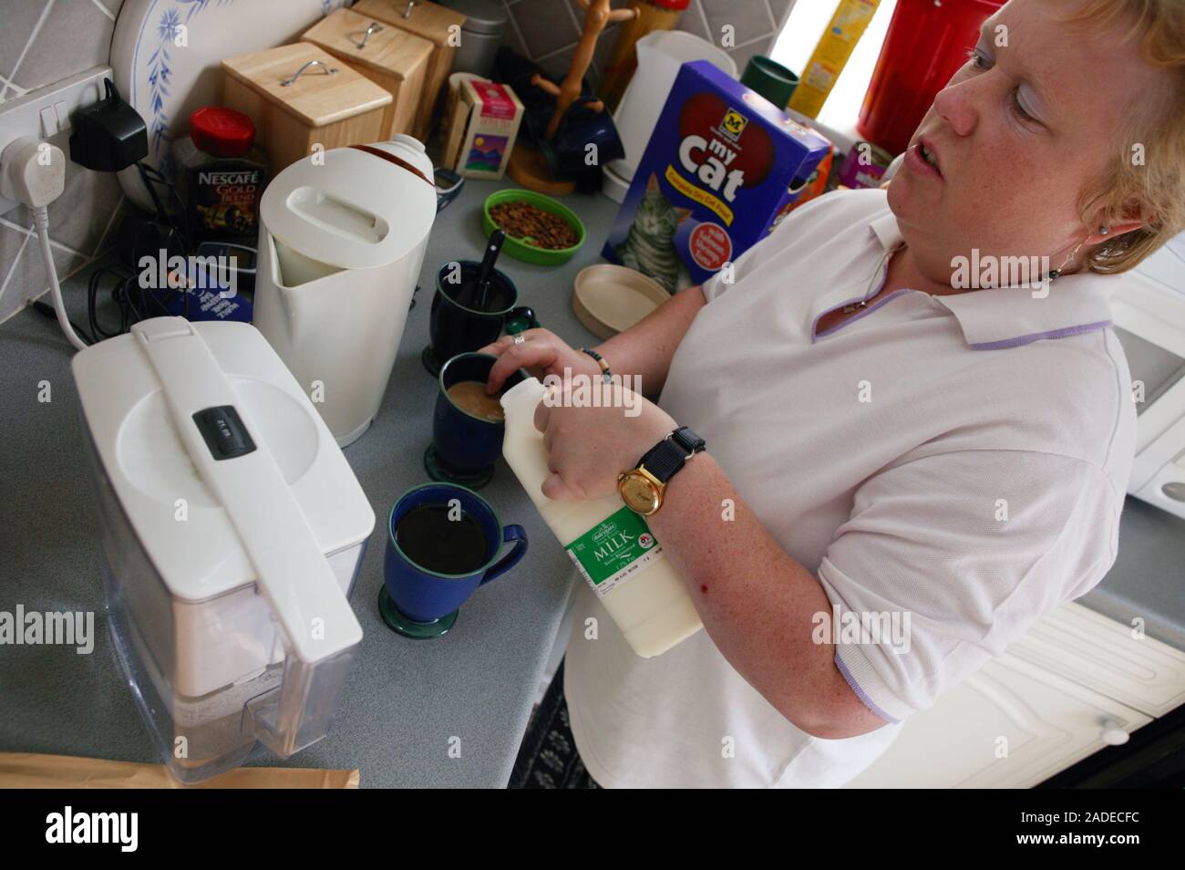 Partially sighted woman making drink Stock Photo - Alamy