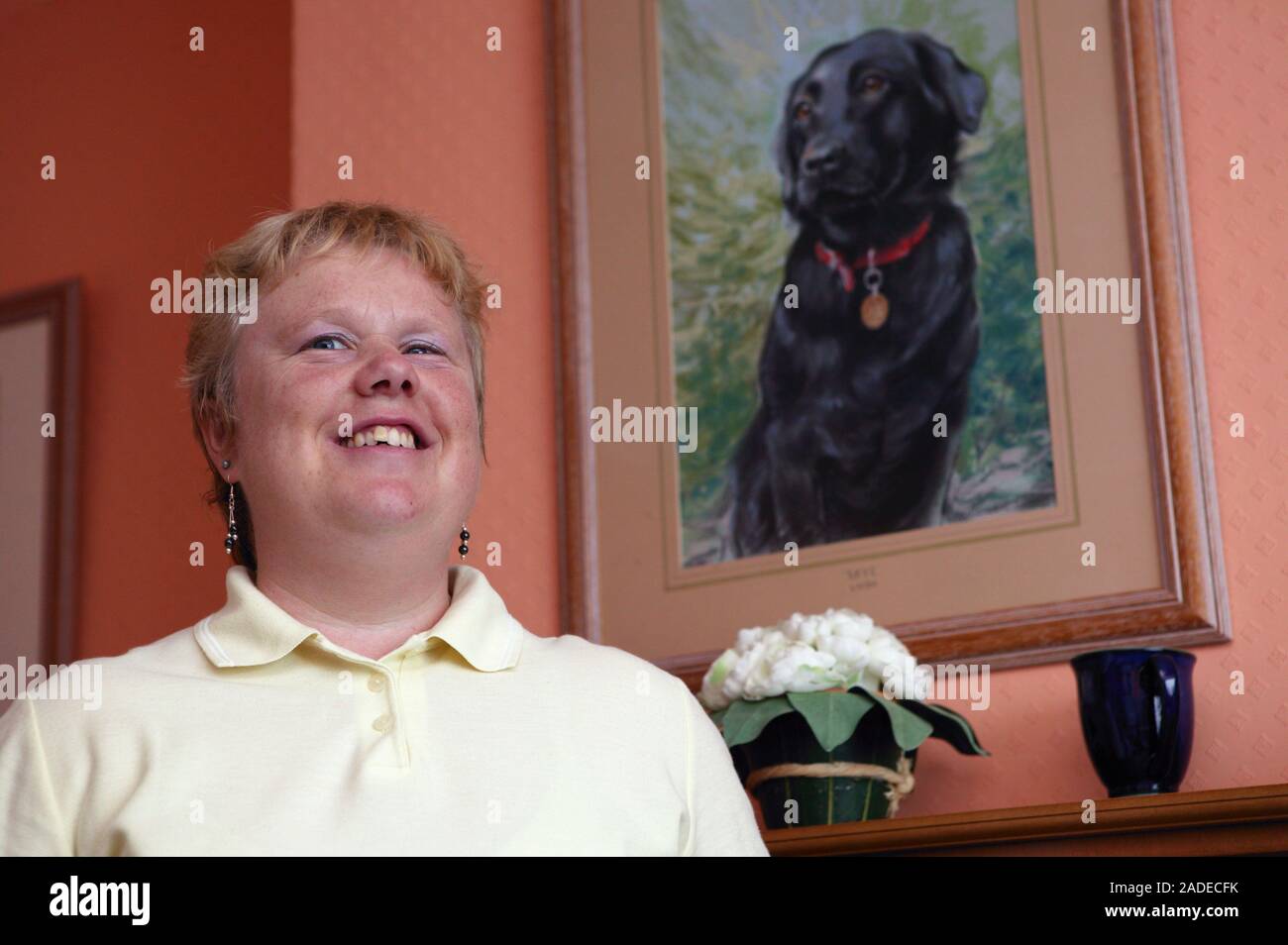 Partially sighted woman with an oil painting of her guide dog Stock ...