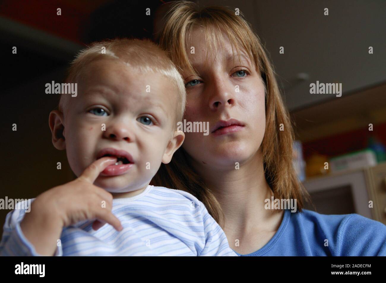 Portrait of a young stressed mother with her baby Stock Photo - Alamy