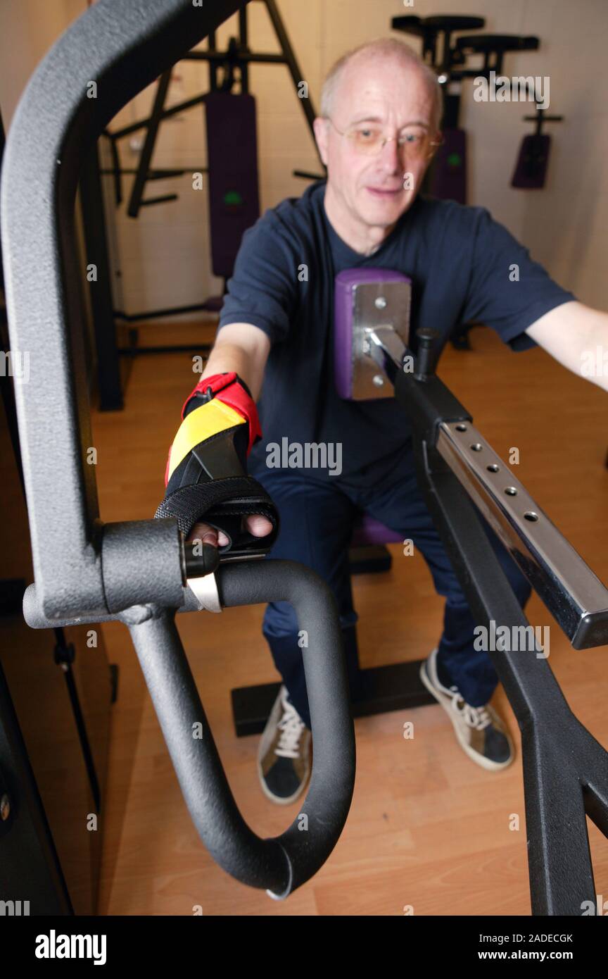 Access to services. Disabled man in the gym, using Seated Row Stock ...