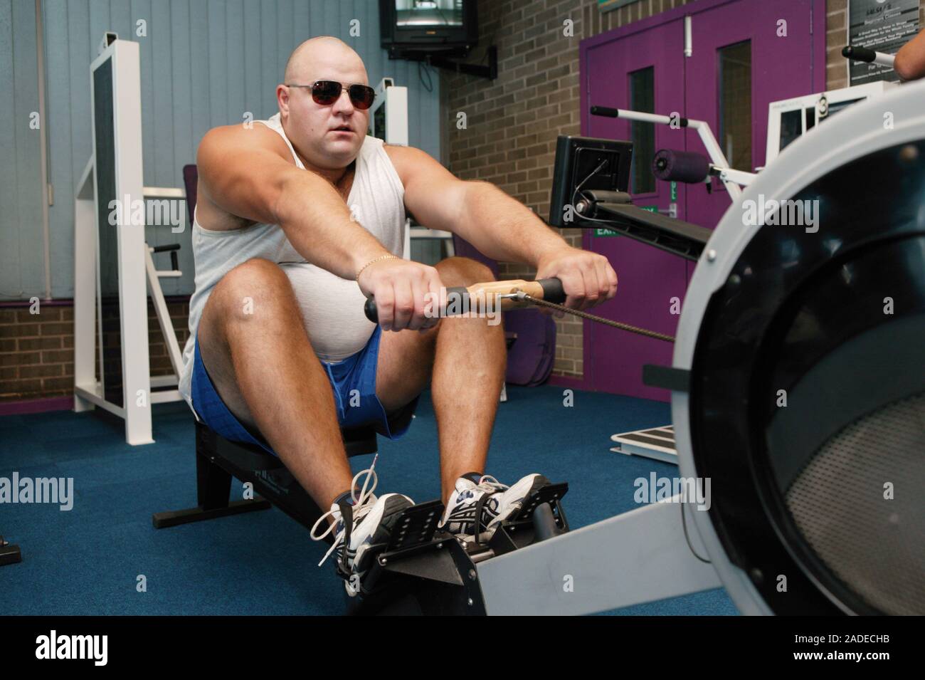 Access to services. Disabled man in the gym, using Rowing Machine Stock ...