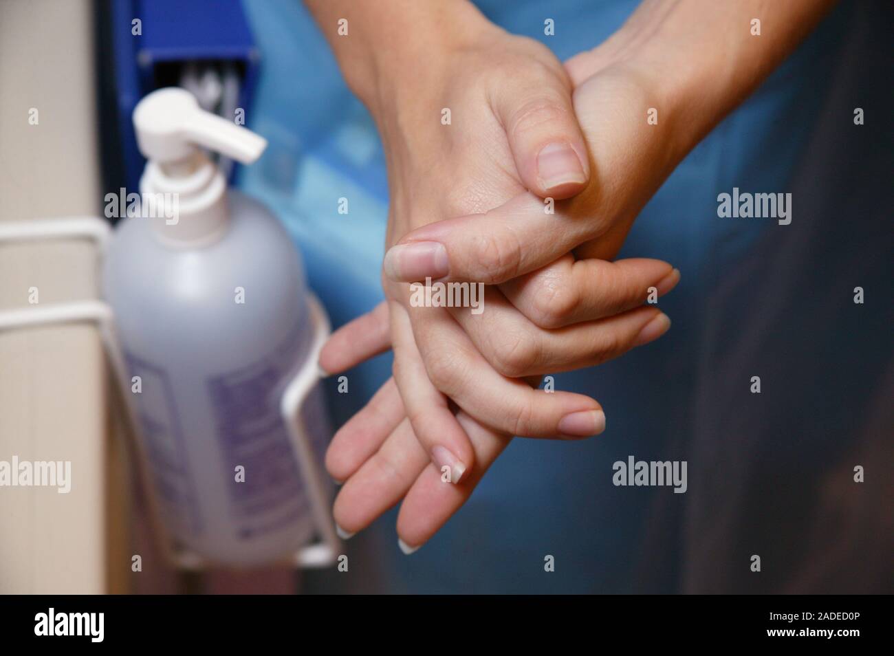 Staff Nurse using handrub at the end of the patients bed to minimise ...
