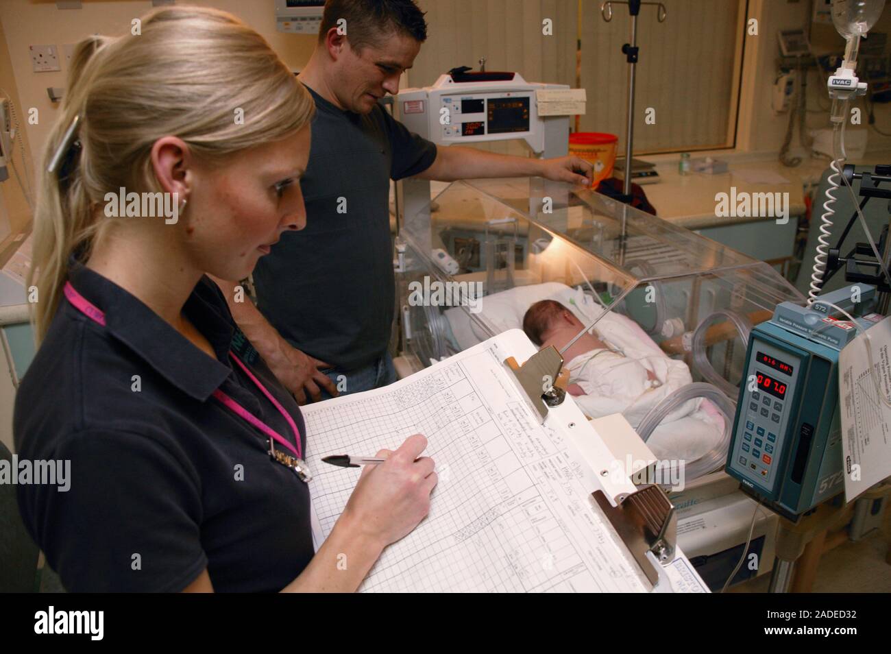 Neonatal Staff nurse taking observations of newborn baby boy in ...