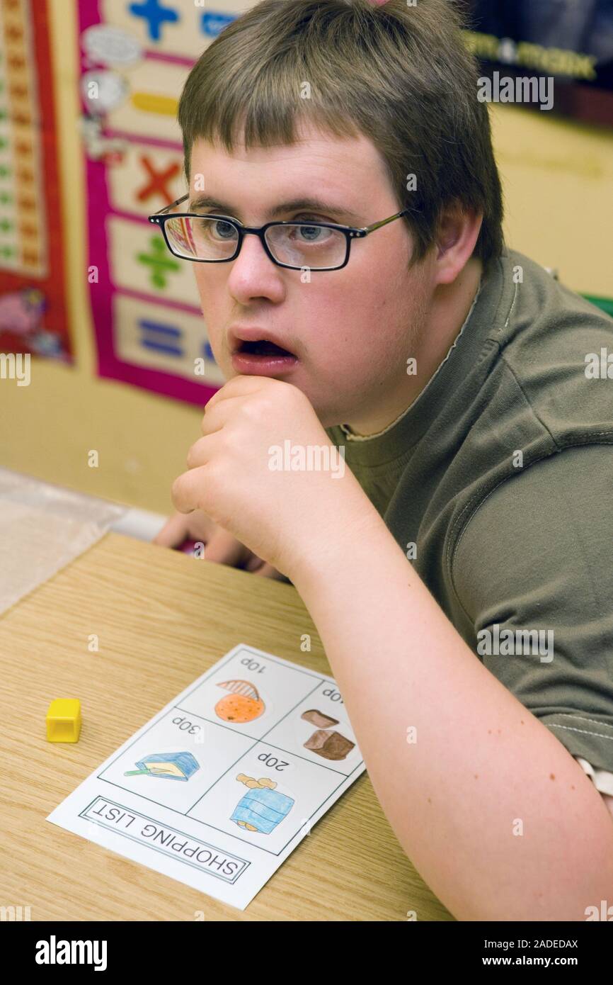 Boy with learning disability sitting at desk in classroom Stock Photo ...