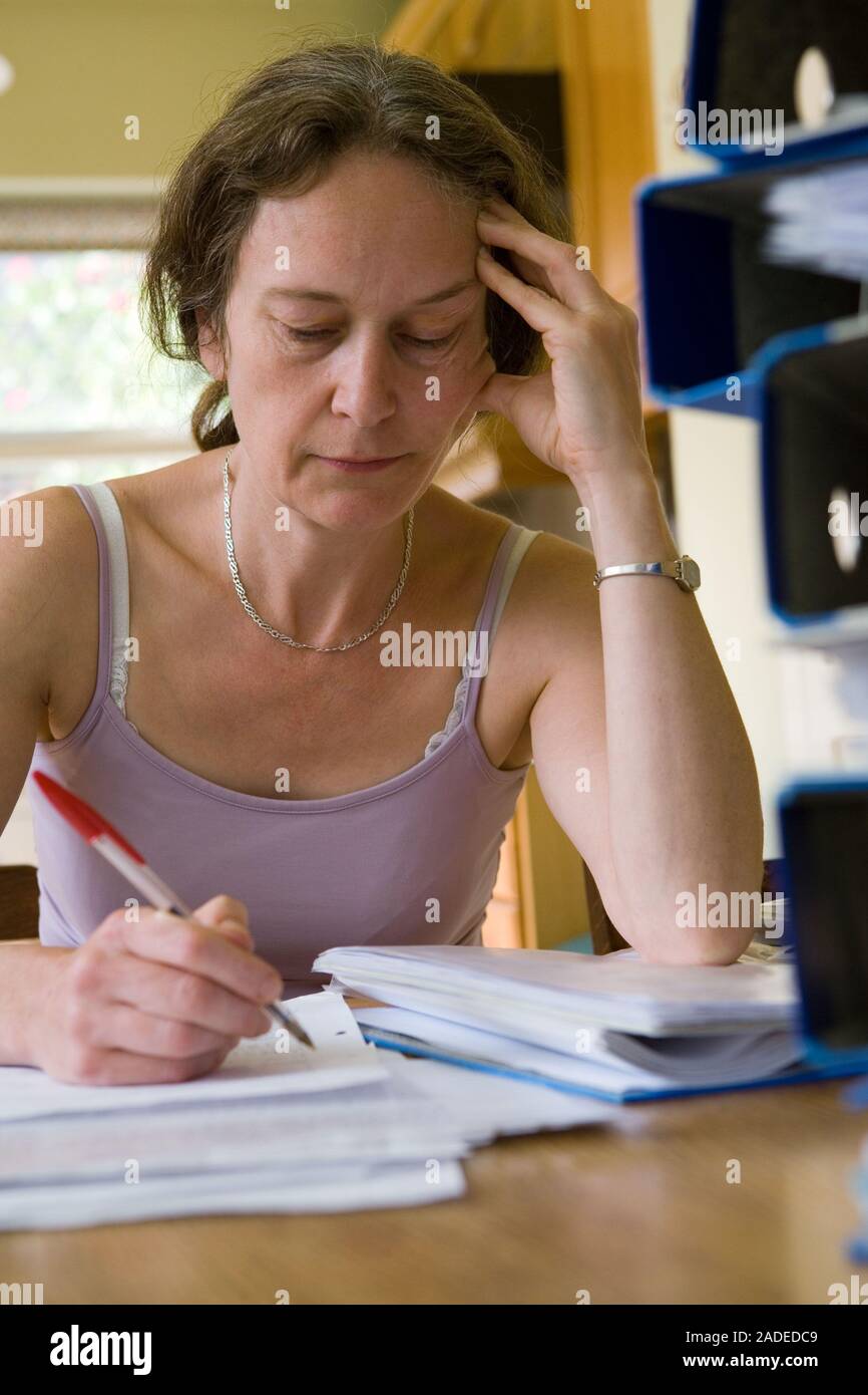 Teacher struggling with the pressure of a backlog of homework to mark ...