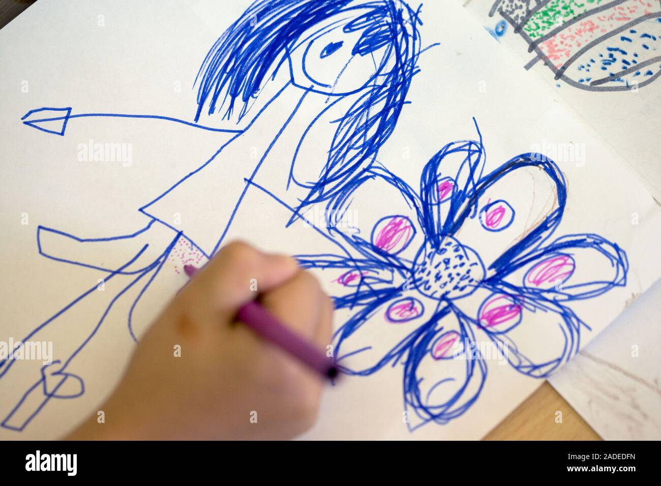 Child drawing a picture with felt tip pen at nursery school Stock Photo ...