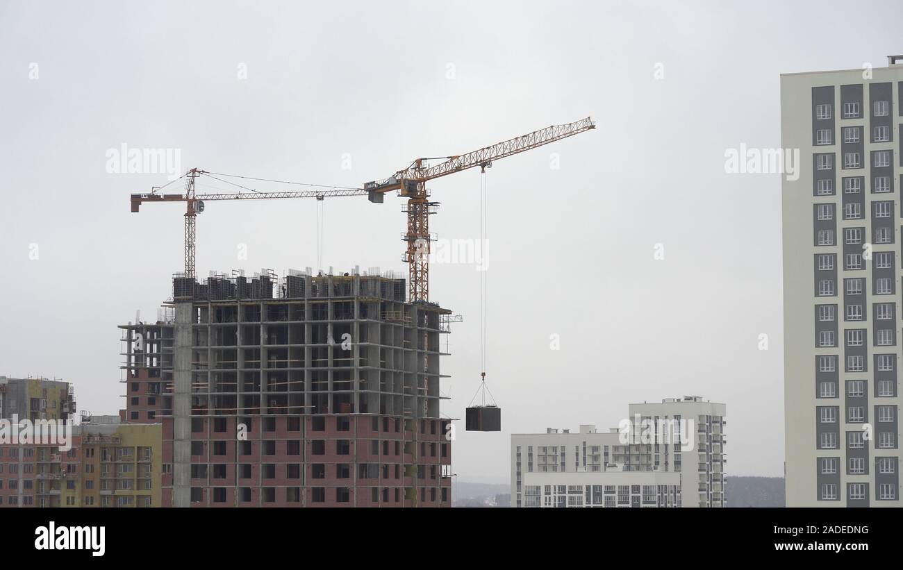 A construction crane lifts a load. Tower Crane on a Construction Site ...