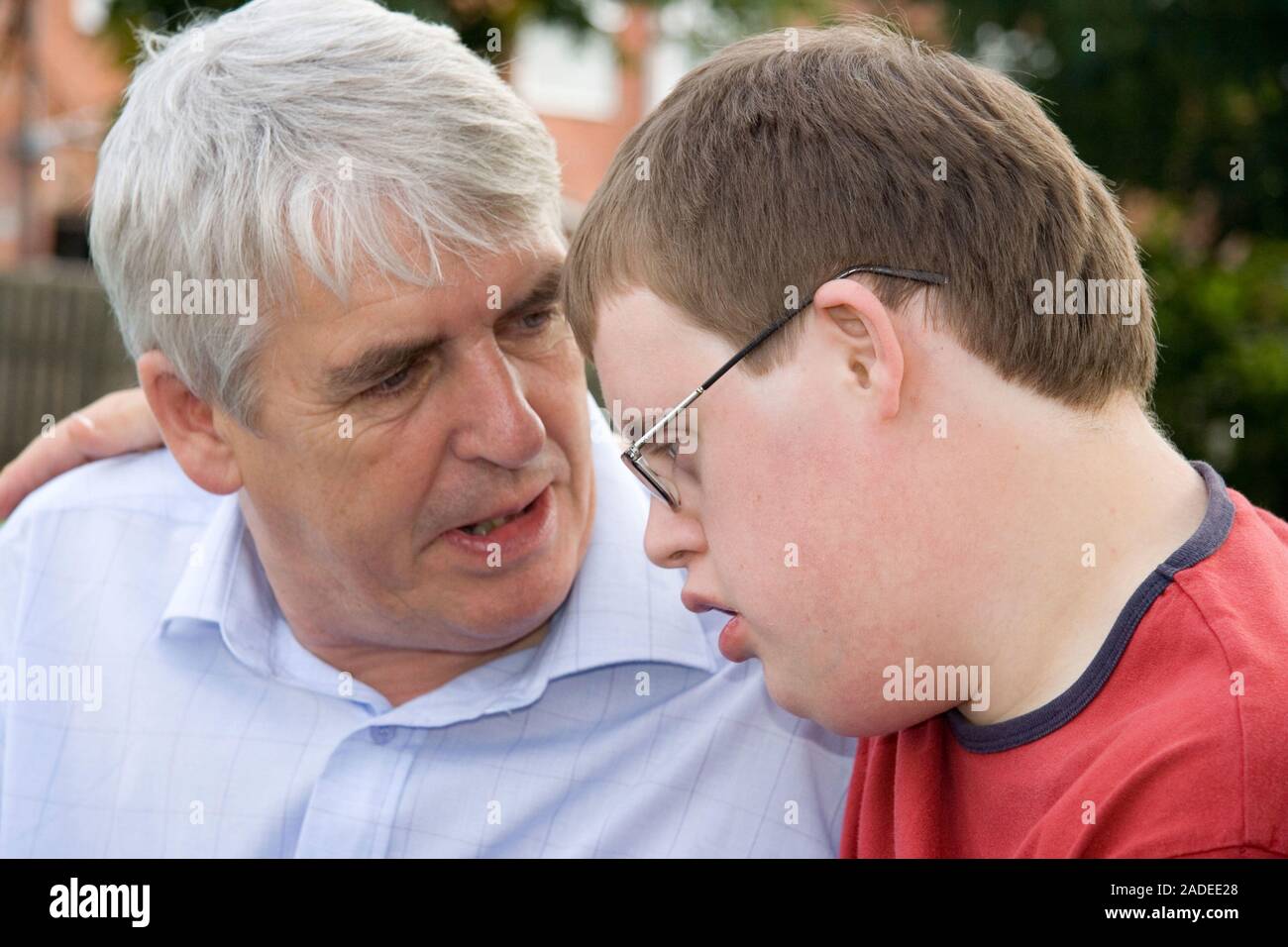 Father talking to teenage son with Down syndrome Stock Photo - Alamy