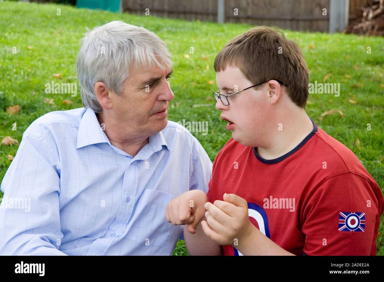 Father talking to teenage son with Down syndrome Stock Photo - Alamy