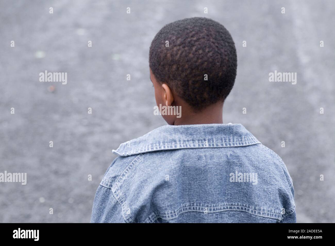 Back view of young boy alone Stock Photo - Alamy