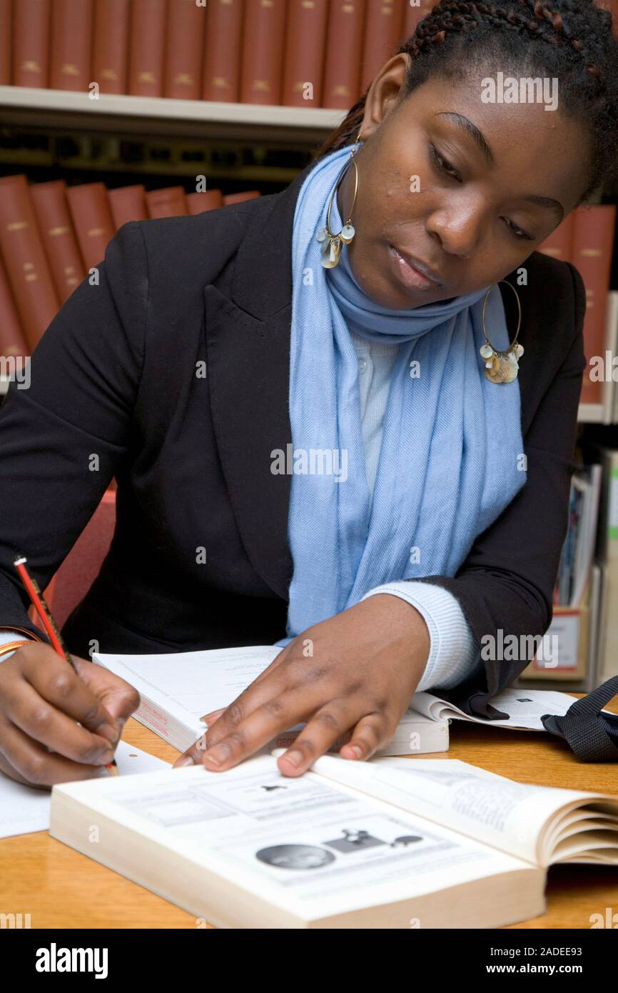 University student studying in the college library Stock Photo - Alamy