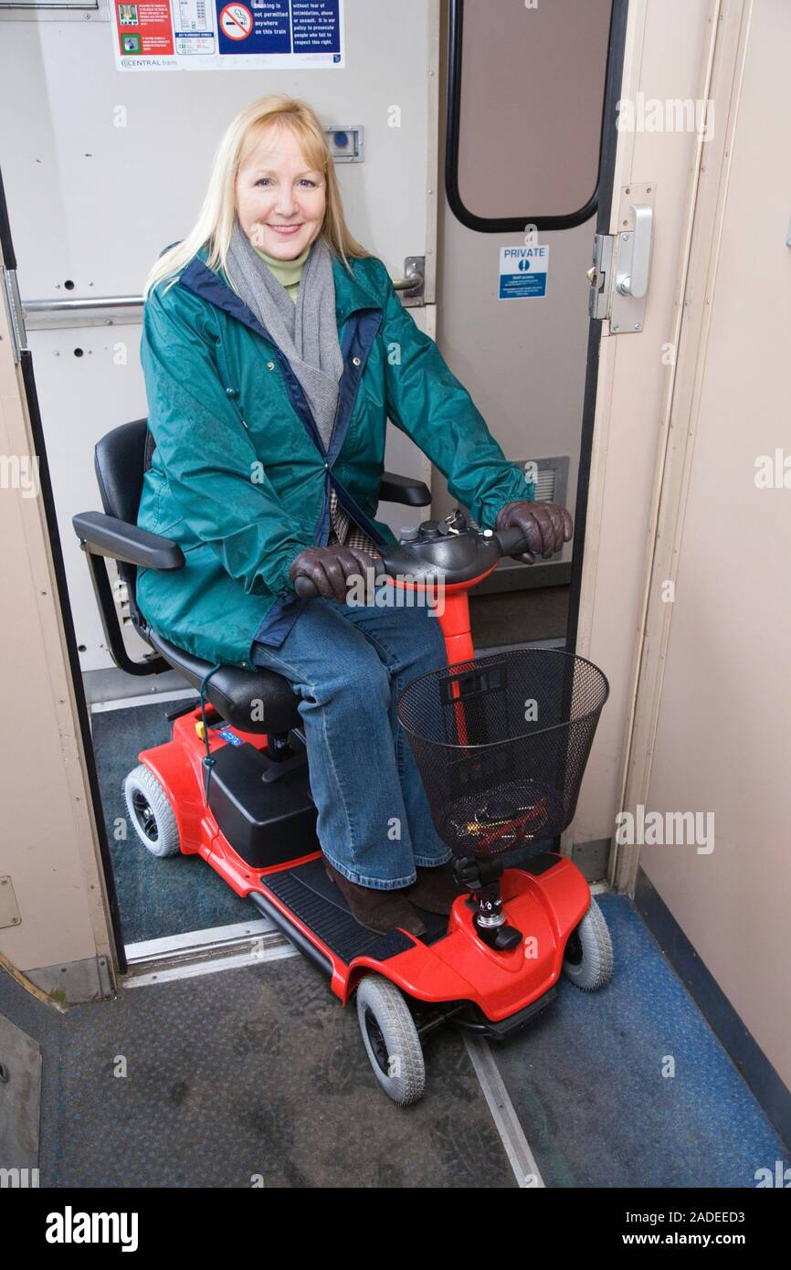 Woman steering electric mobility scooter into a train carriage Stock ...