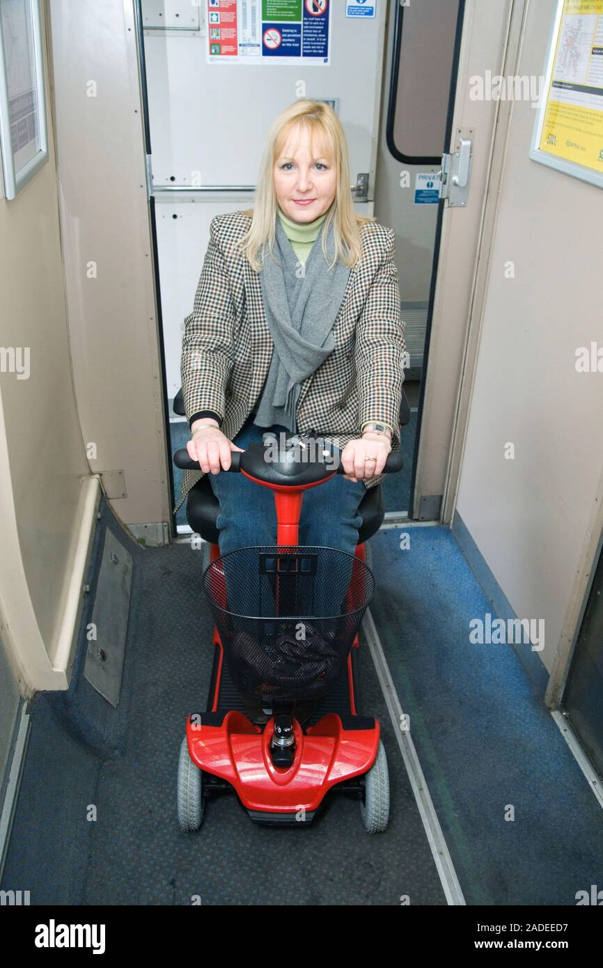 Woman steering electric mobility scooter into a train carriage Stock ...