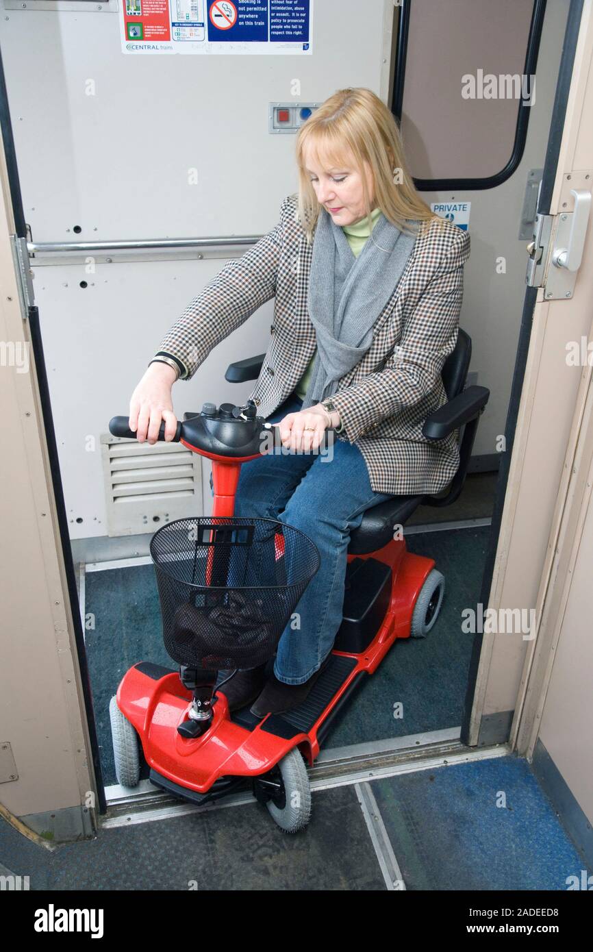 Woman steering electric mobility scooter into a train carriage Stock ...