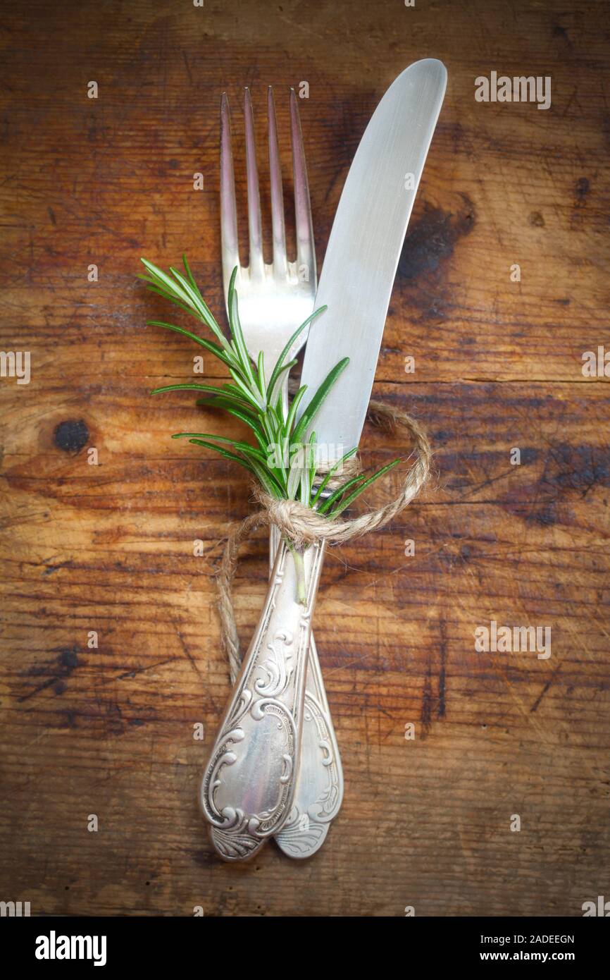 A Silver Knife And Fork With A Rosemary Twig Stock Photo - Alamy