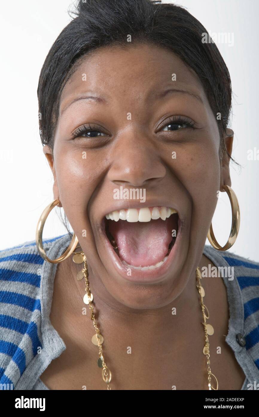 Studio portrait of a teenage girl laughing Stock Photo - Alamy