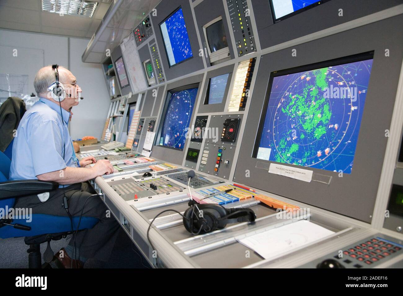 Air Traffic Control Tower Operator watching radar screens at East ...
