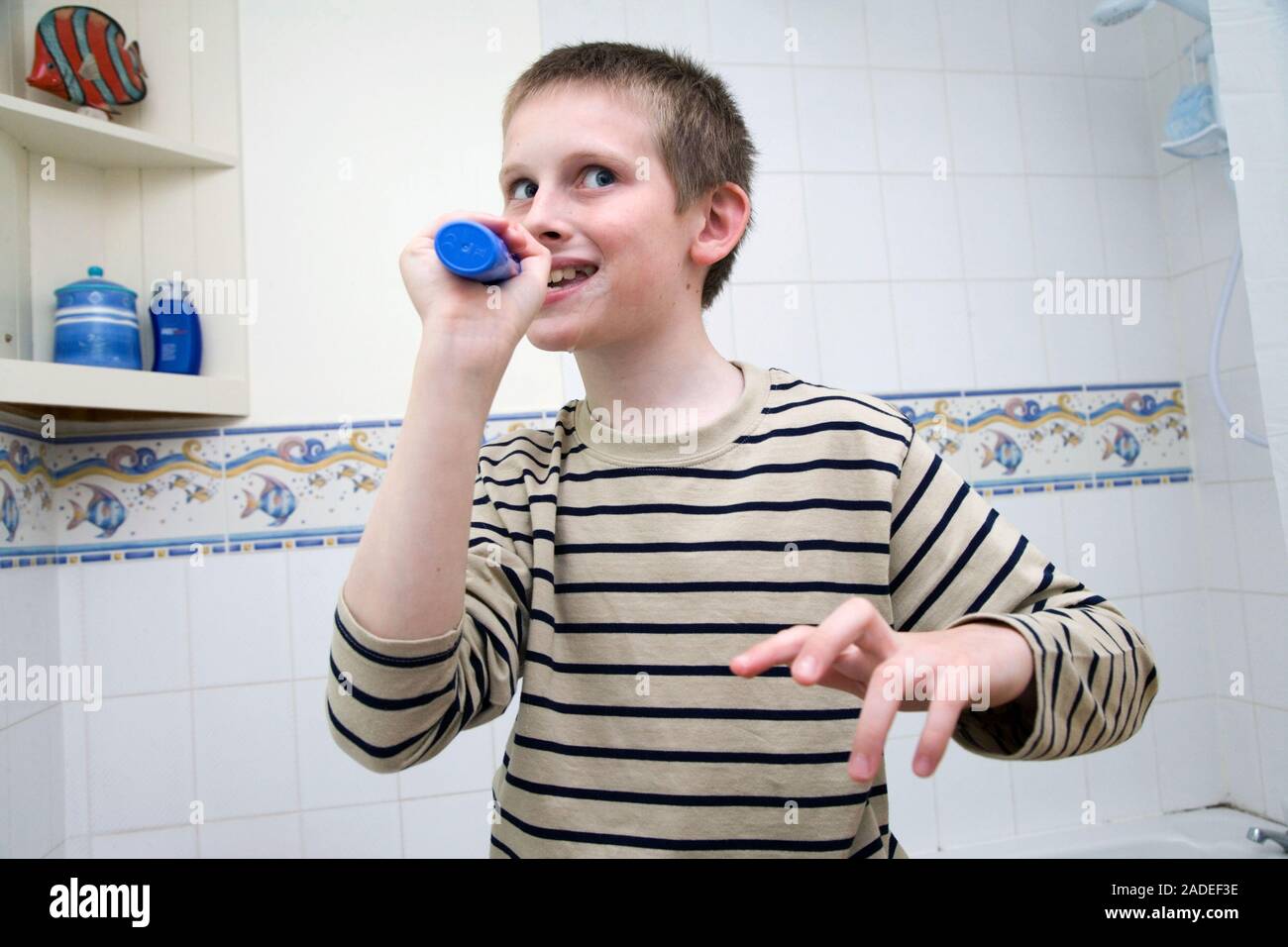 Boy with autism cleaning his teeth Stock Photo - Alamy