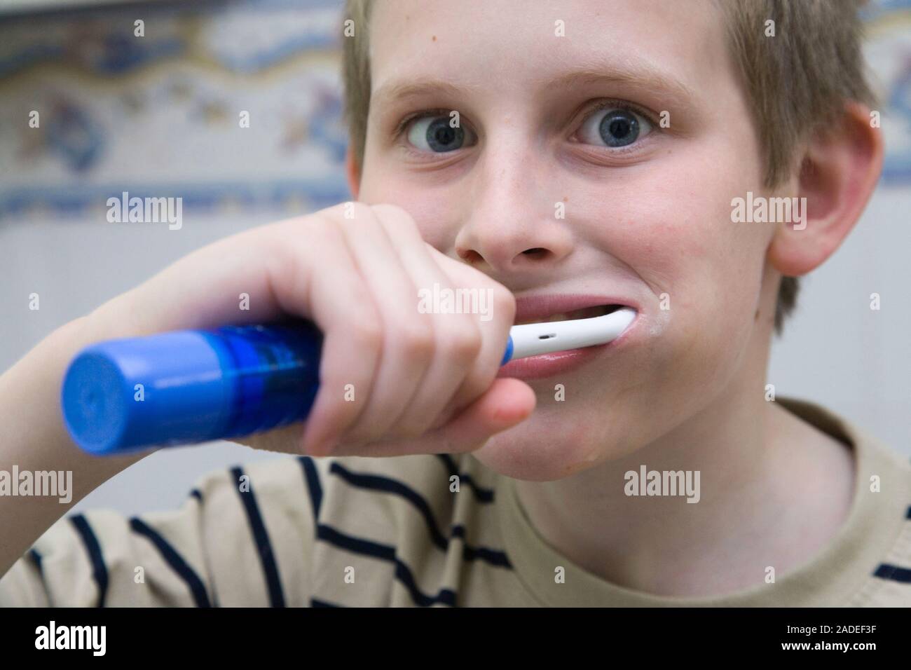 Boy with autism cleaning his teeth Stock Photo - Alamy