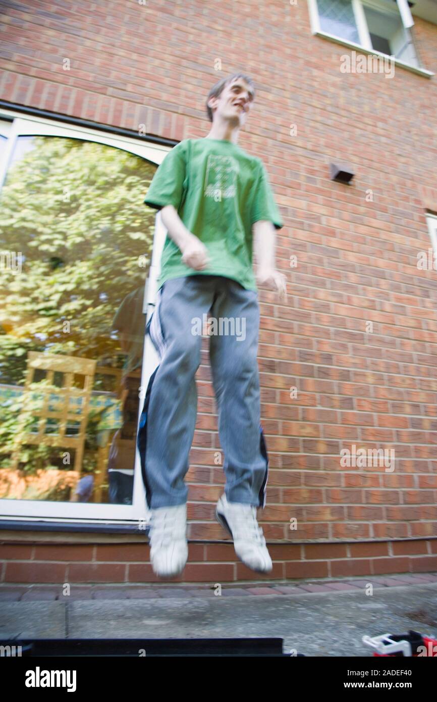 Teenage boy with autism jumping Stock Photo - Alamy