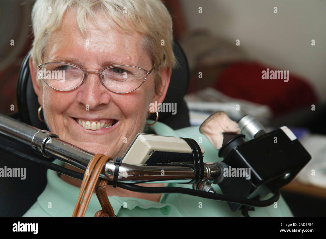 Woman with cerebral palsy with chin-operated wheelchair steering system ...