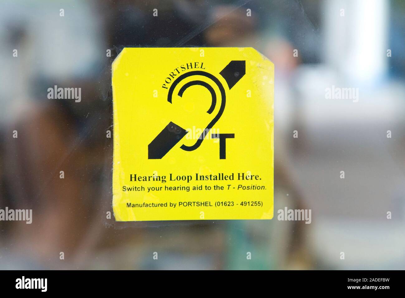 Hearing loop sign for hearing impaired Stock Photo - Alamy