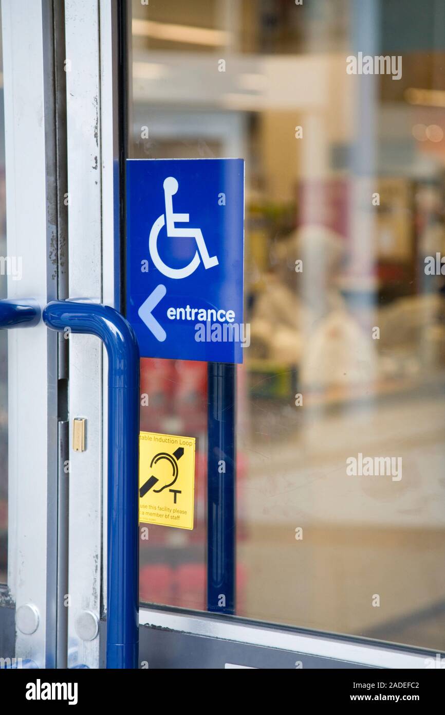 Shop door with disability access and induction loop sign Stock Photo ...