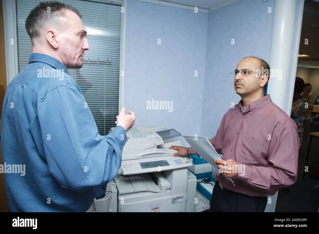 Men in office with photocopier Stock Photo - Alamy