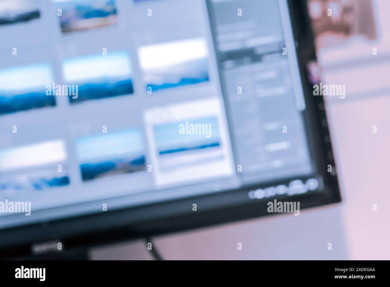 Blurred desktop monitor background with processed photographs in the ...