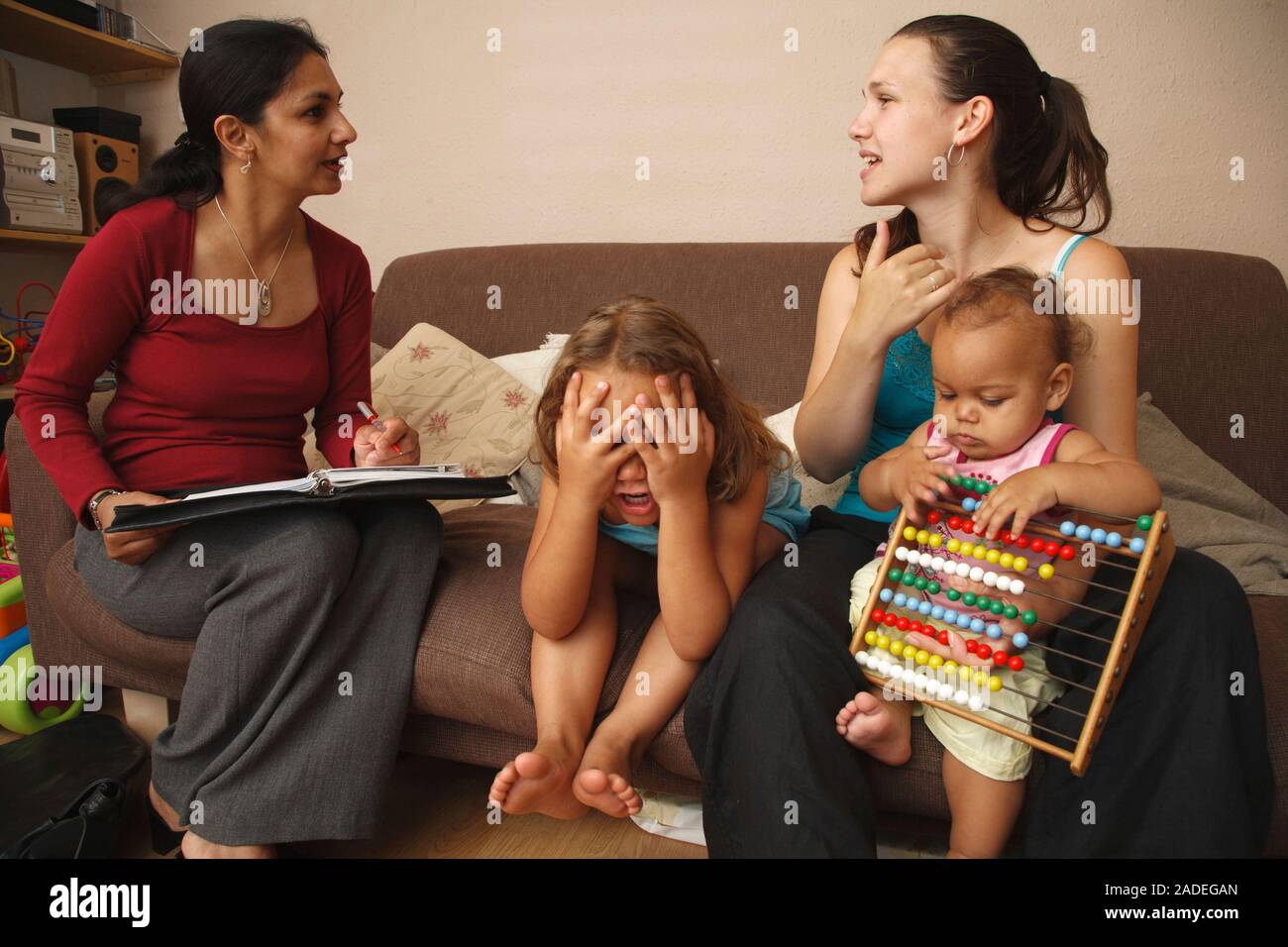 Social worker with young mother and children Stock Photo - Alamy