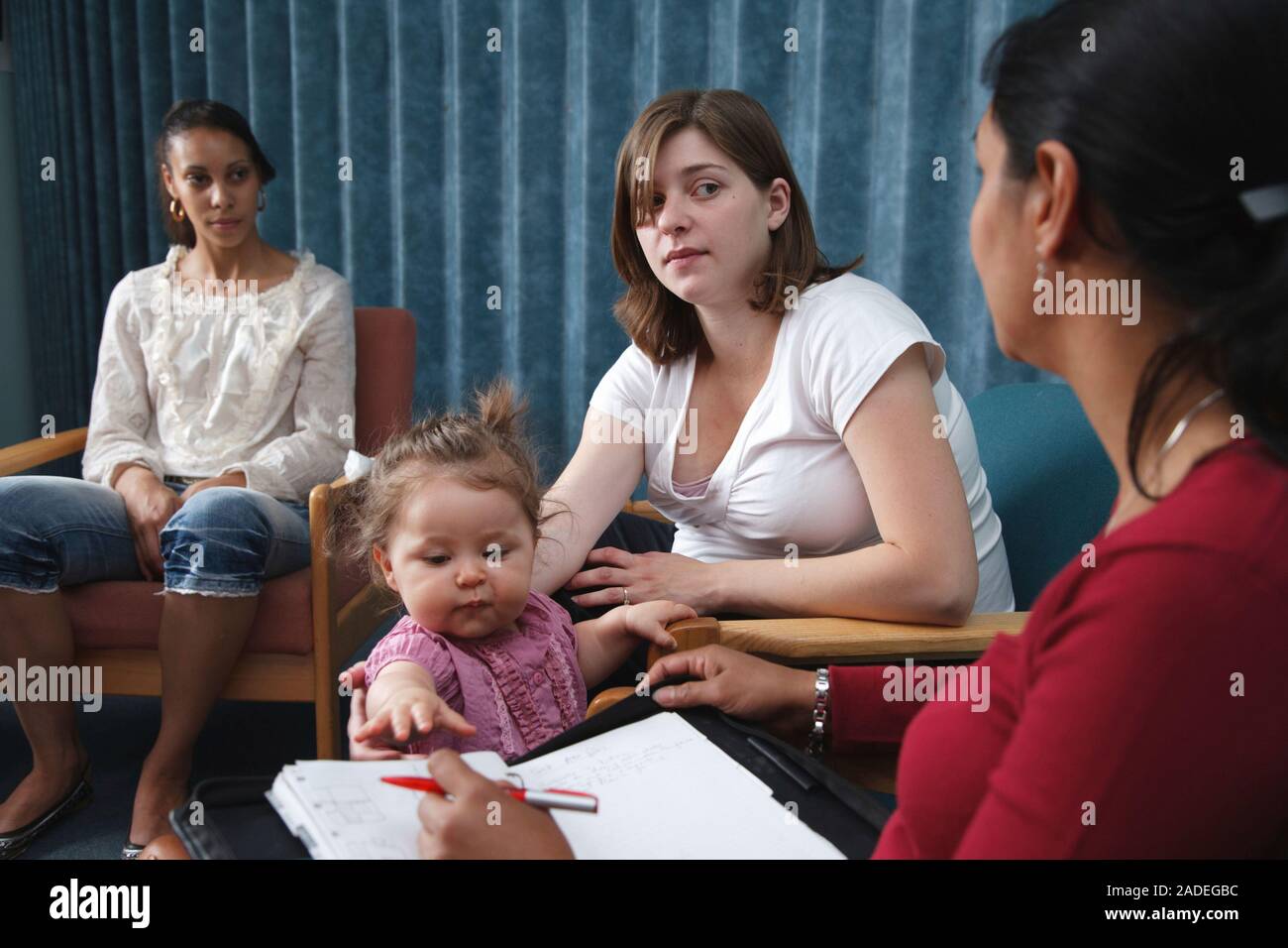 Social worker in discussion group with young mothers and children Stock ...