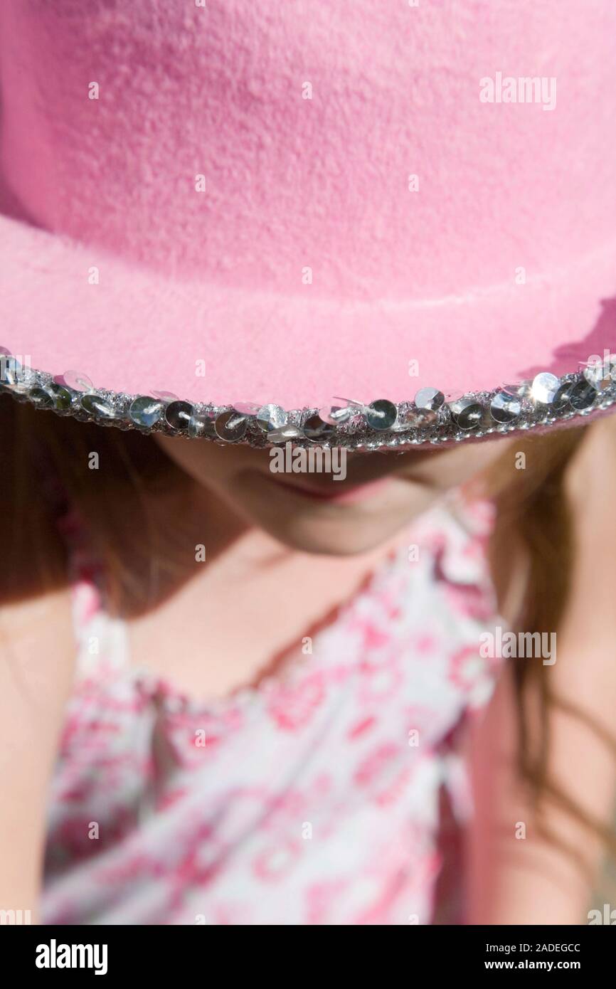 Little girl hiding under a hat Stock Photo - Alamy