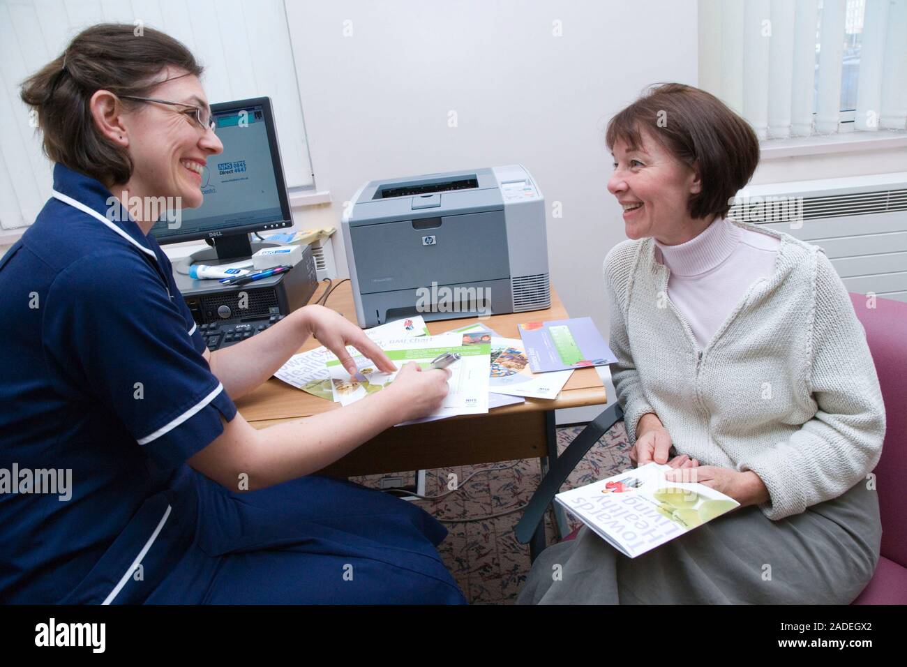 Community nurse discussing health issues with patient Stock Photo - Alamy