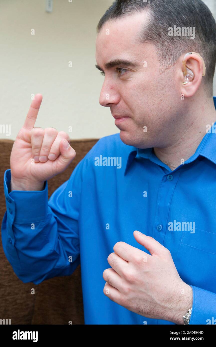 Man with a hearing impairment talking using sign language Stock Photo ...