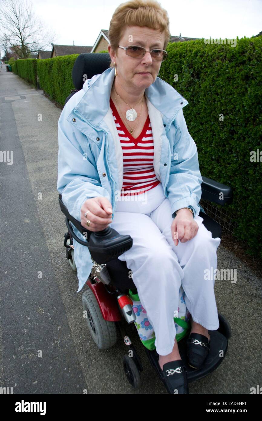 Older woman wheelchair user going down the road Stock Photo - Alamy