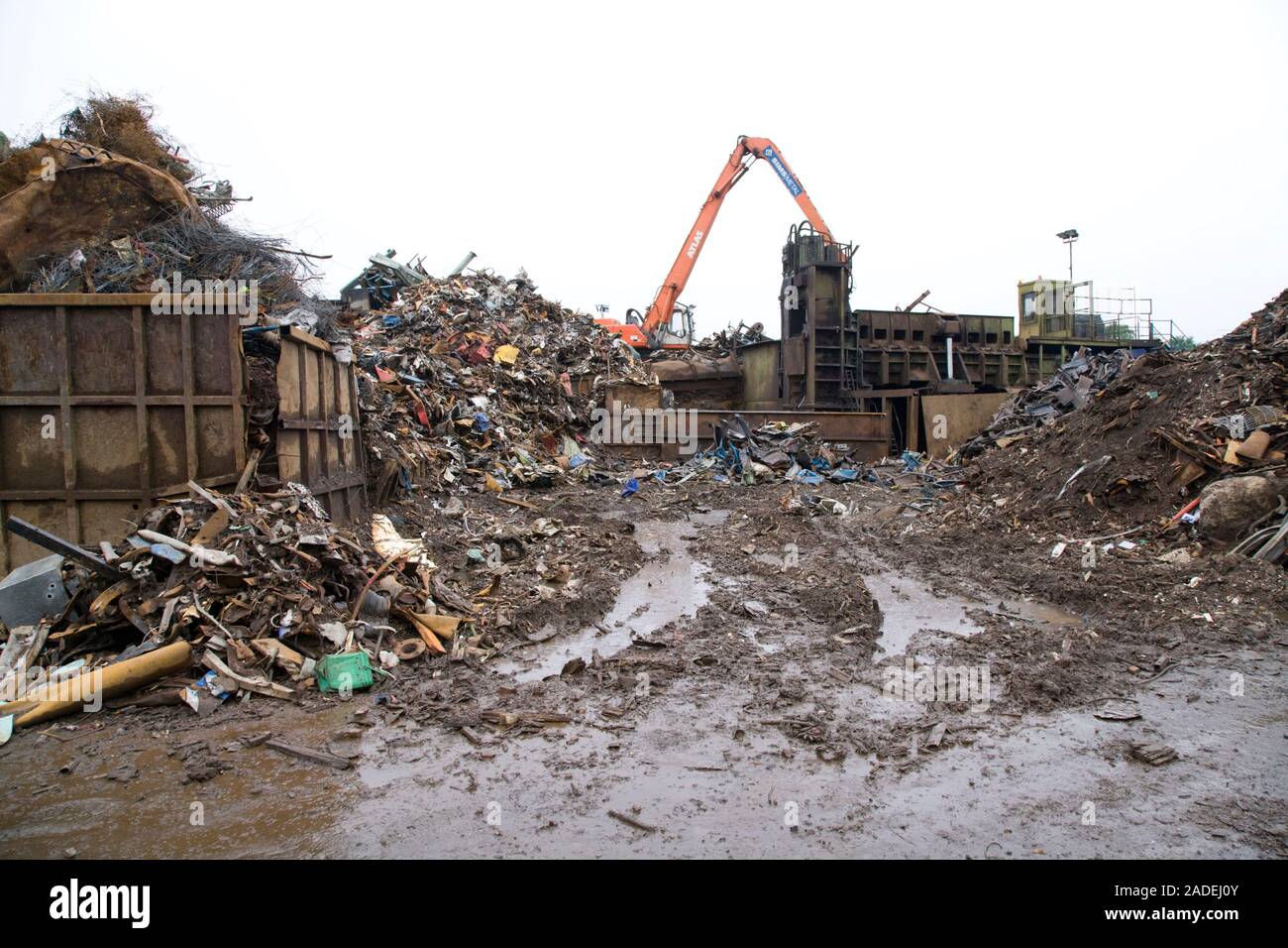 Hydraulic grab machine lifting heavy scrap steel which will be sheared ...