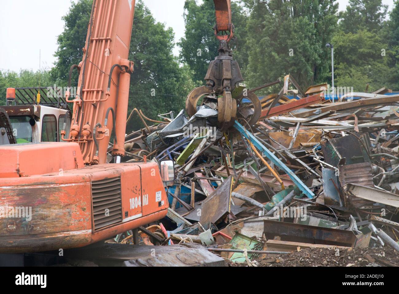 Hydraulic grab machine lifting heavy scrap steel which will be sheared ...