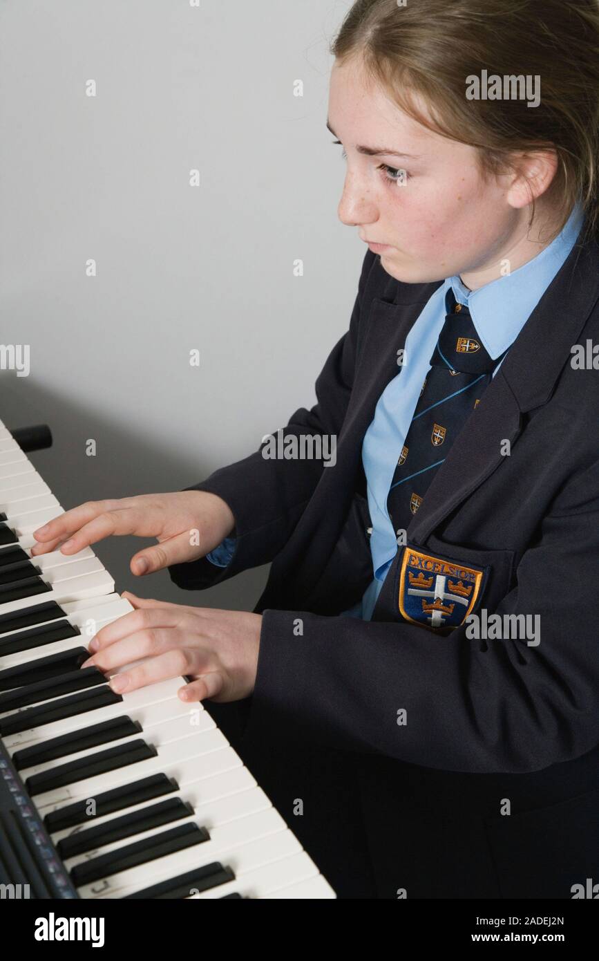 Secondary school student playing the piano in a music lesson Stock ...